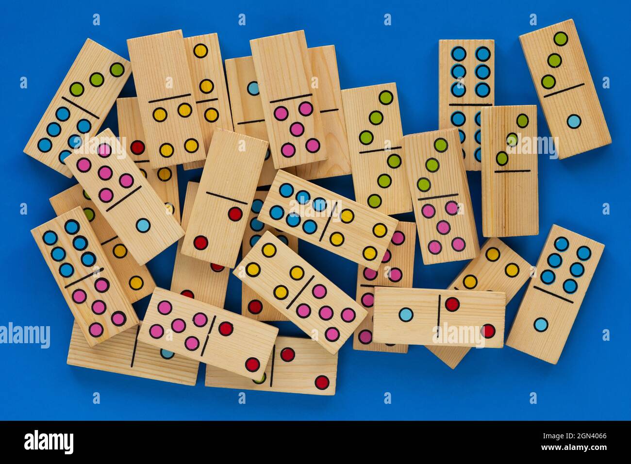 Top view of heap wooden dominoes gaming pieces on blue background Stock ...