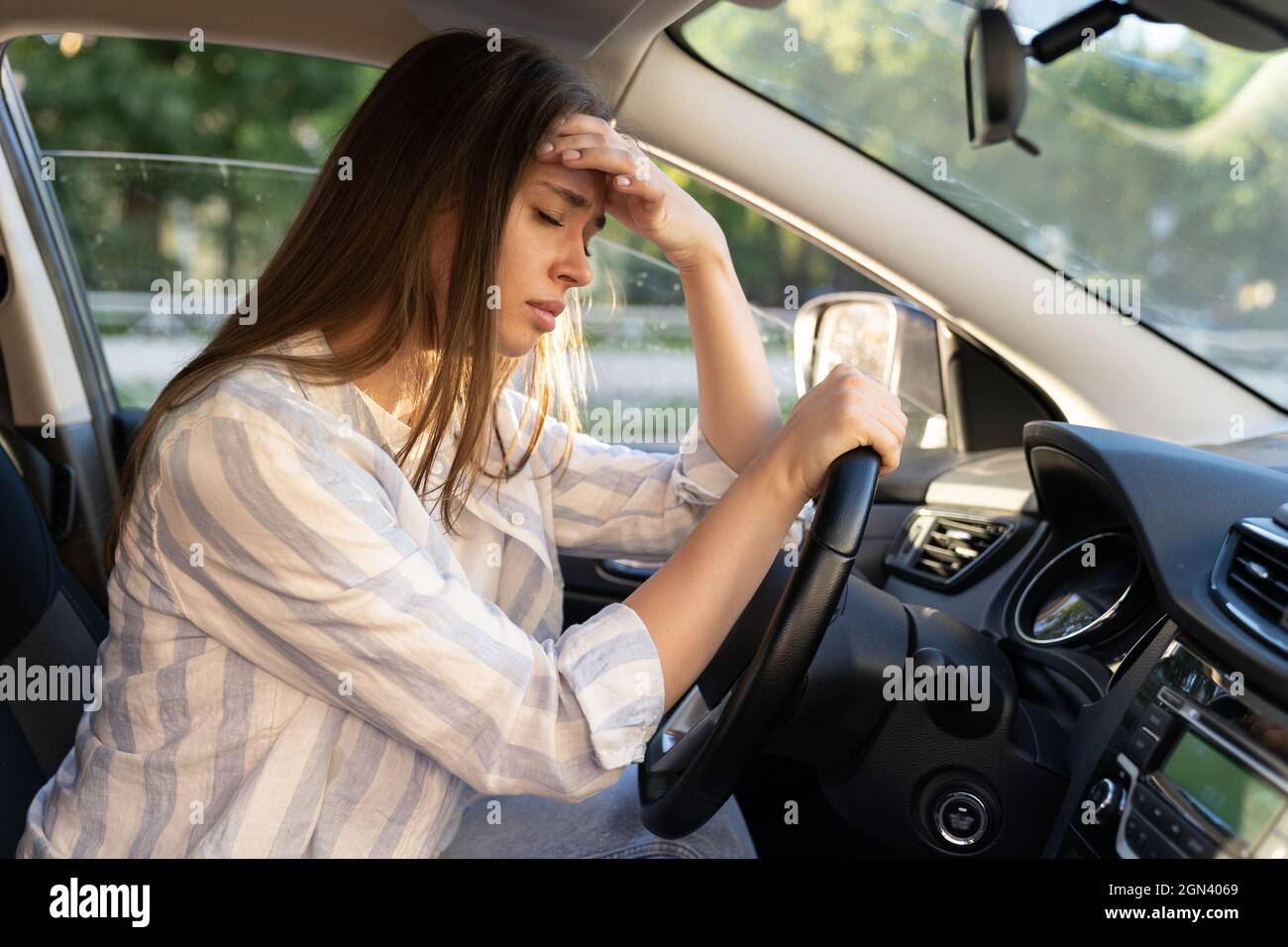 Tired young woman car driver suffer from headache or migraine pain ...