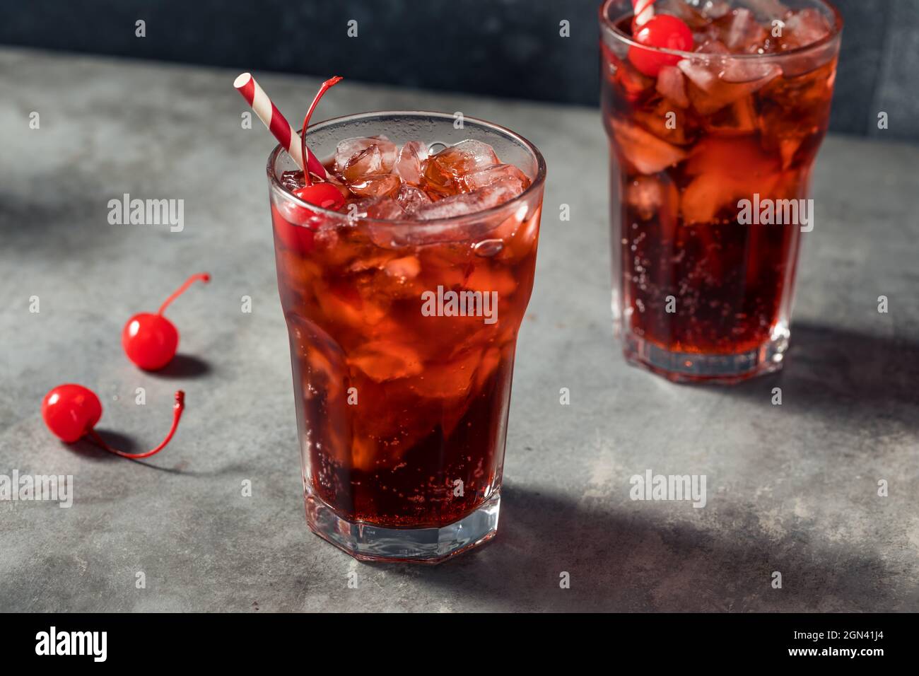 Cold Refreshing Cherry Cola in a Glass with Ice Stock Photo - Alamy