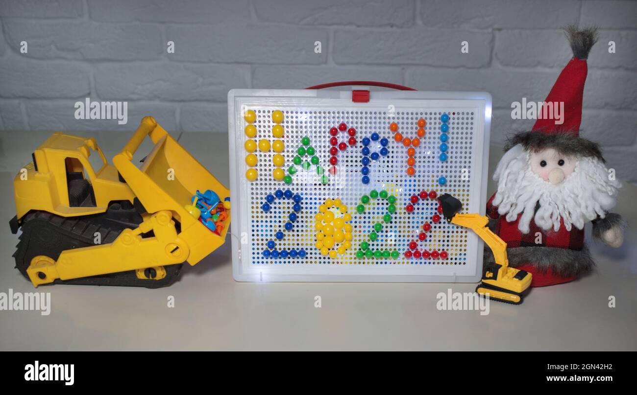 happy 2022 lined with plastic colored mosaic. Santa claus, toy yellow ...