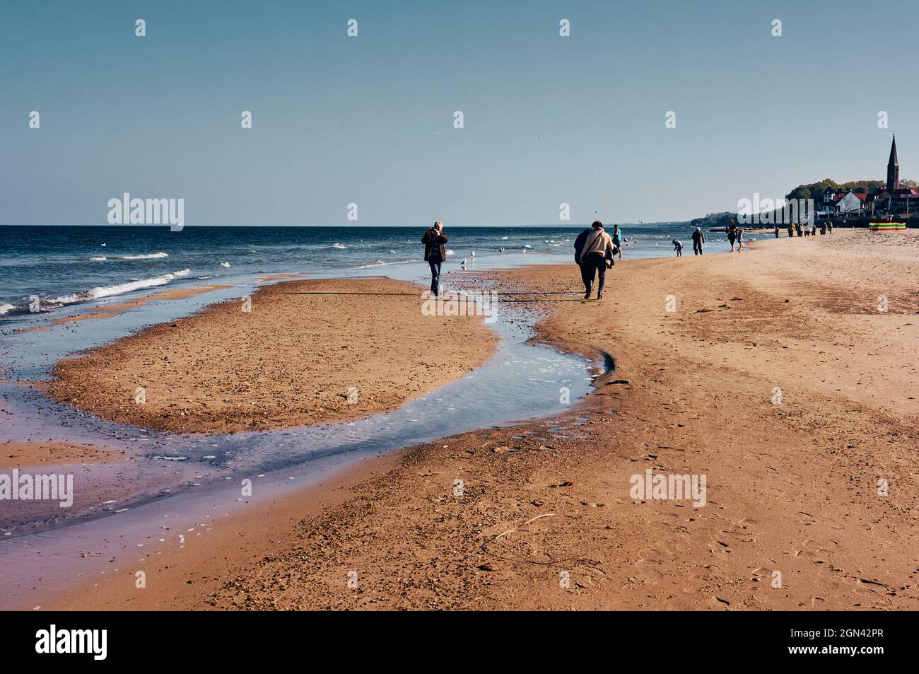 SARBINOWO, POLAND - Oct 16, 2017: The people walking on a sandy beach ...