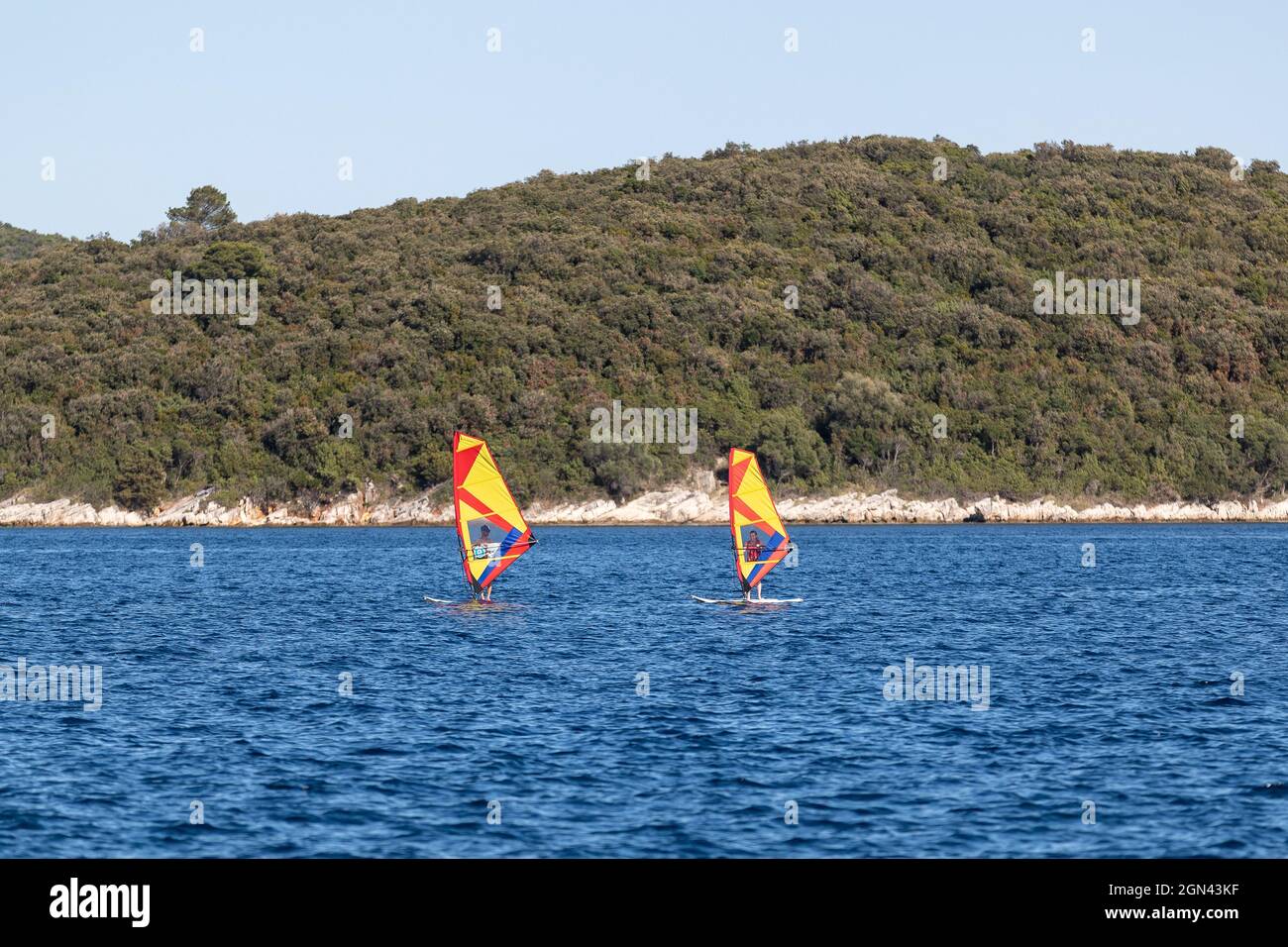 Serene scenery of people wind surfing in the lake in Croatia ...