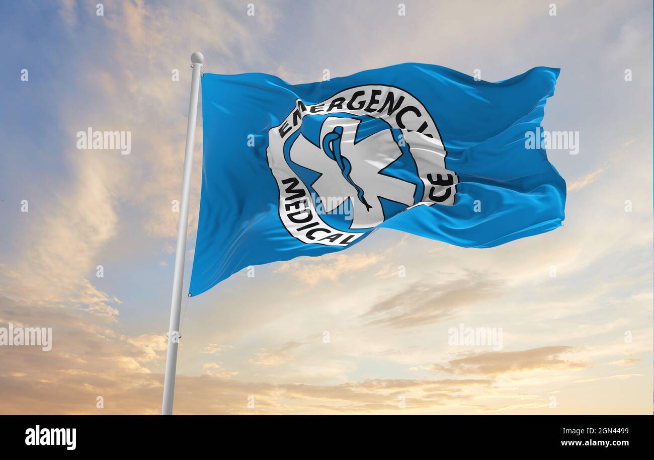 Emergency Medical Services flag waving at sky background on sunset ...