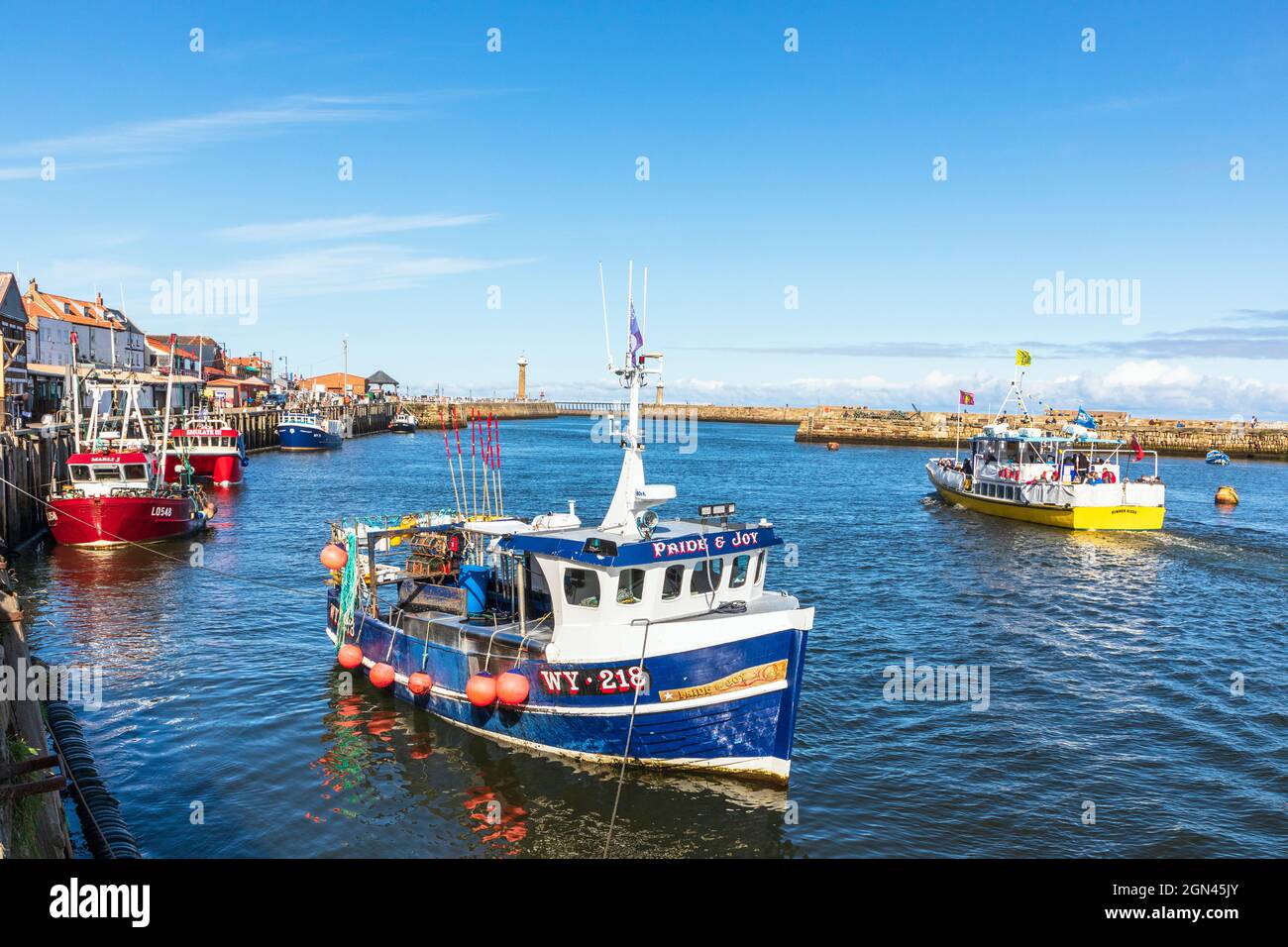 General view of Whitby harbour, with fishing boats, and a motor boats ...