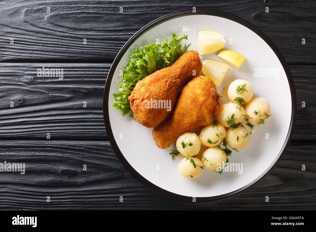 Austrian Fried Chicken Backhendl served with lemon and new potatoes ...