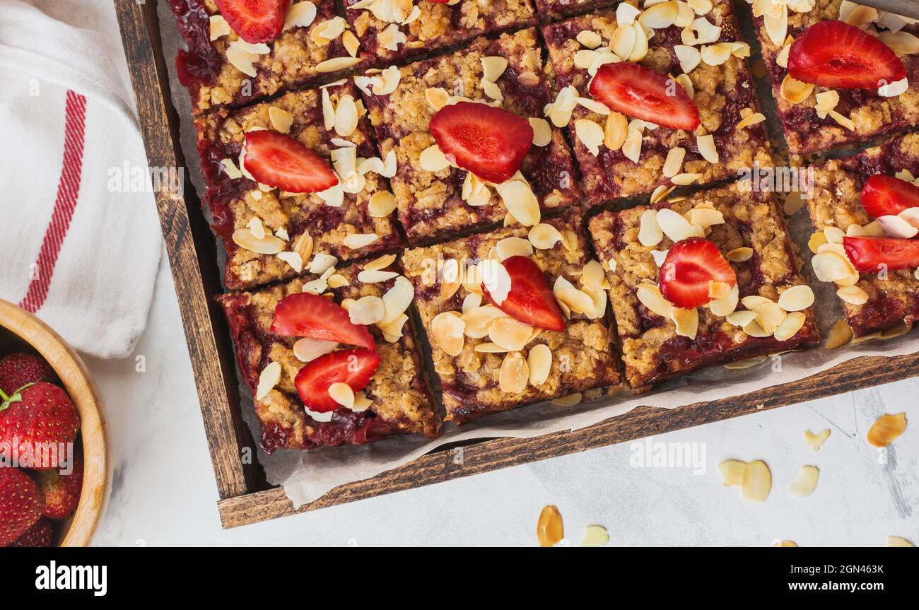 Dessert Squares with Strawberries and Oat Streisel on light concrete ...