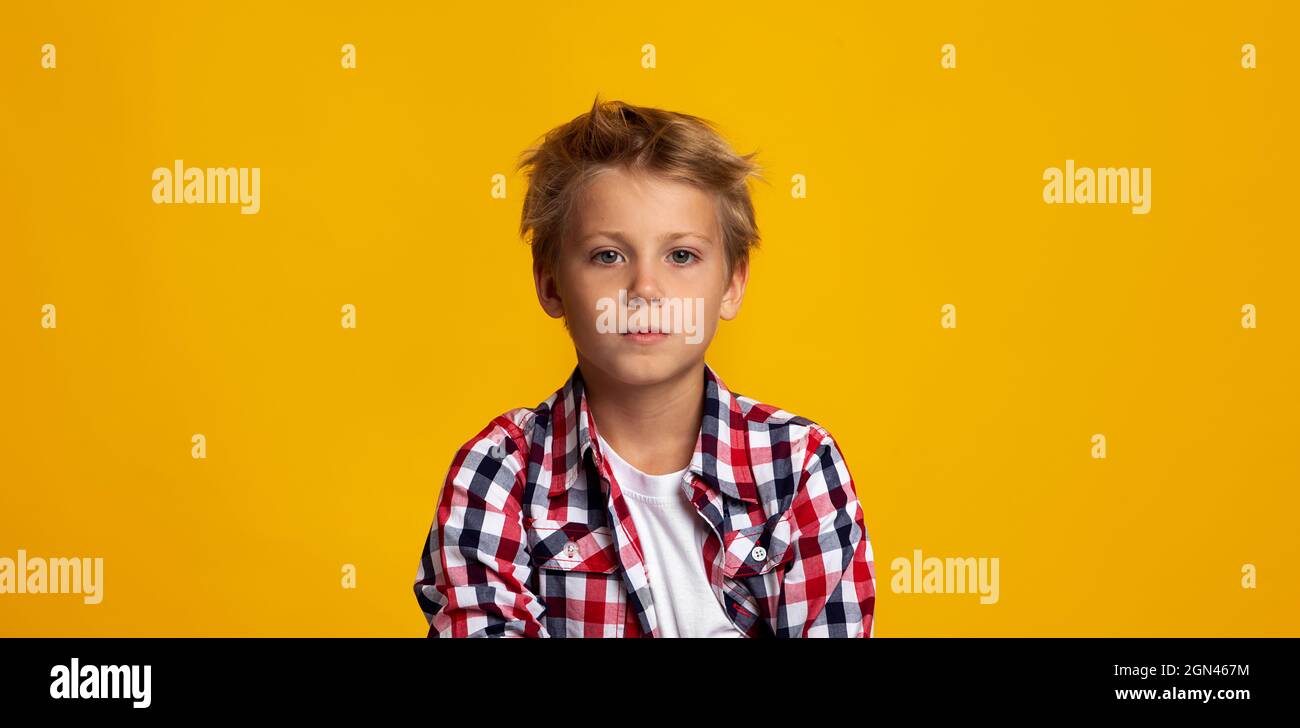 Serious seriously calm cute caucasian teenage boy looking at camera ...