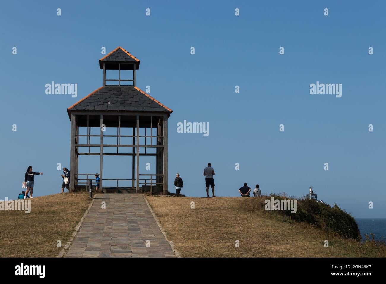 Hill with people enjoying themselves on it under a clear blue sky in ...