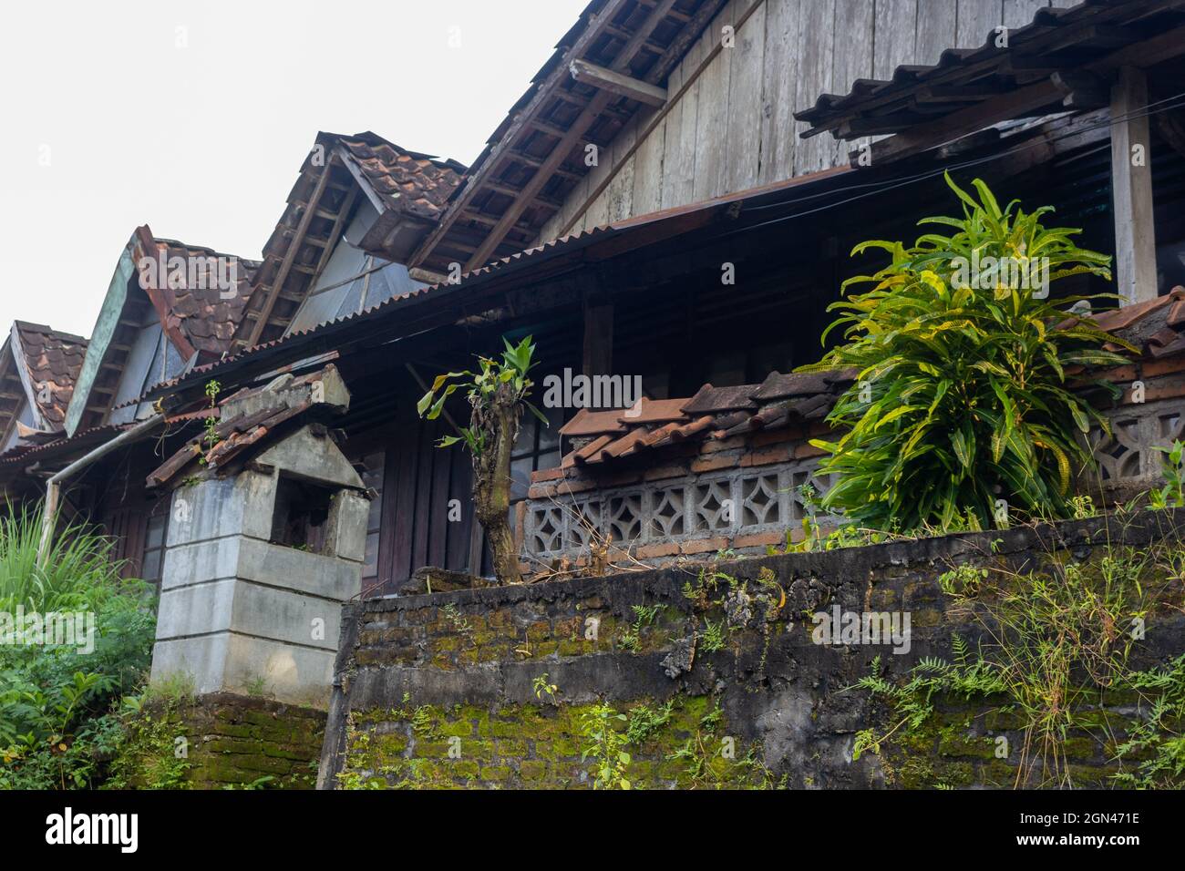 Old building built on a mossy brick base with tile roofs and wooden ...