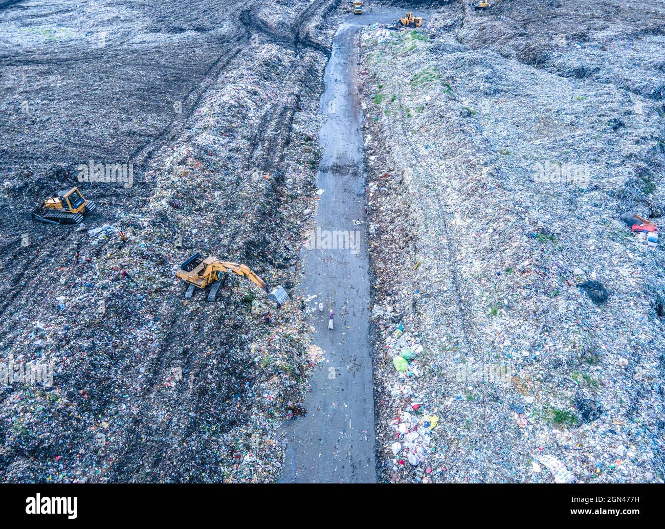 Aerial vie taked with a drone of trash collectors on a garbage deposit ...