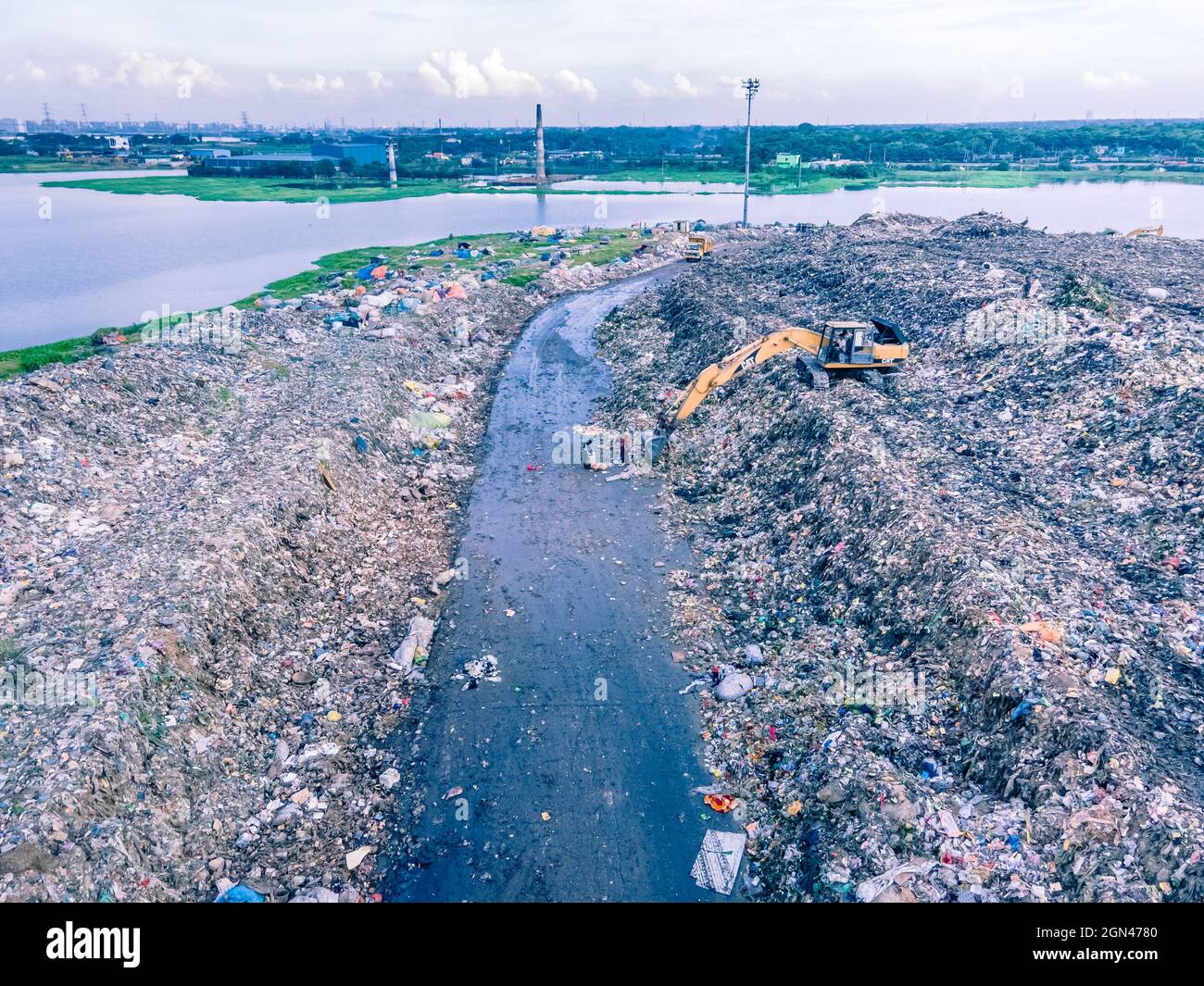 Aerial vie taked with a drone of trash collectors on a garbage deposit ...