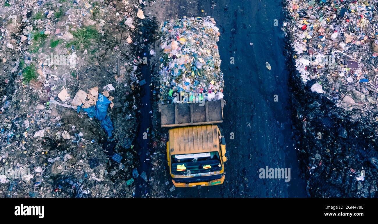 Aerial vie taked with a drone of trash collectors on a garbage deposit ...