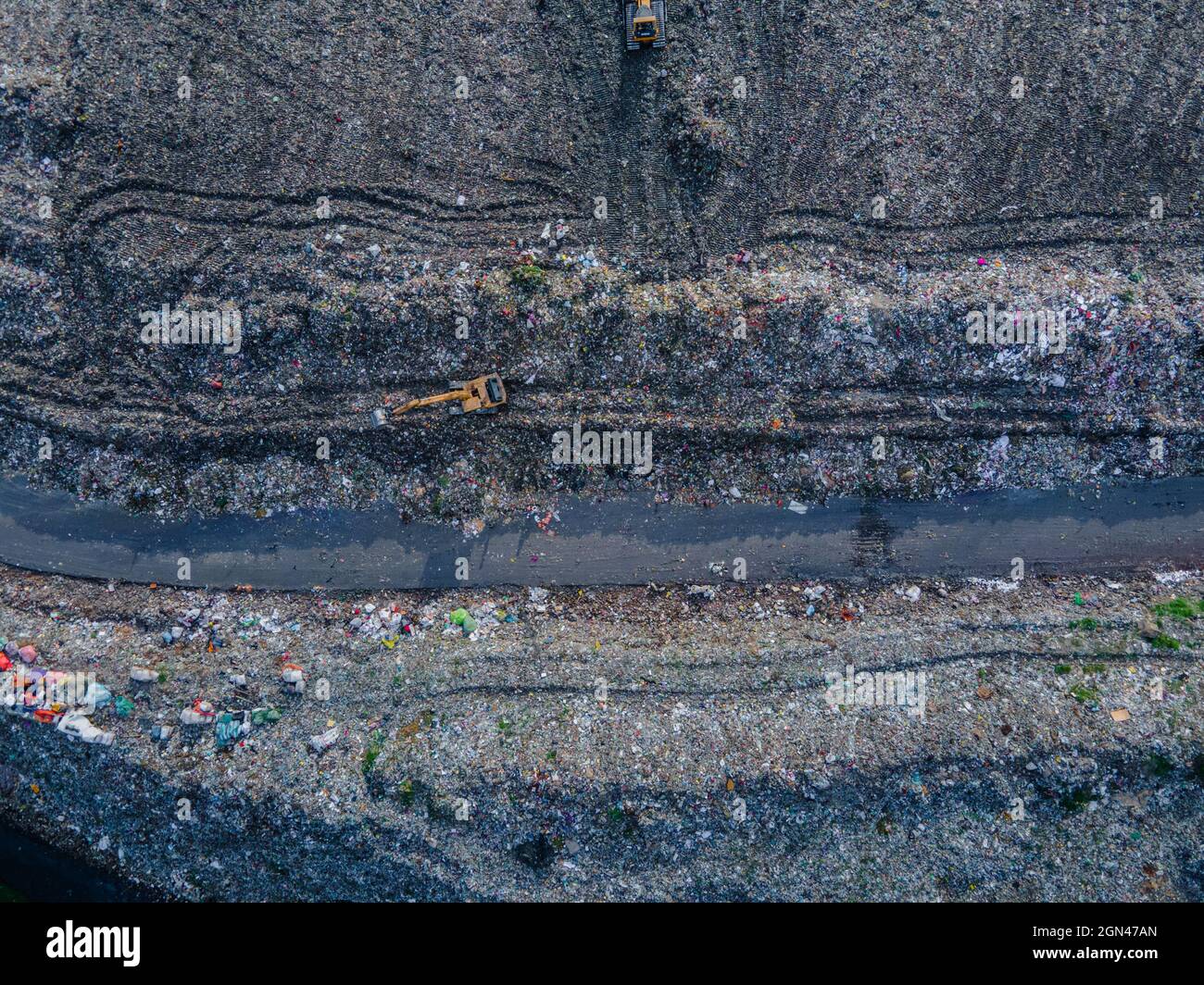 Aerial vie taked with a drone of trash collectors on a garbage deposit ...