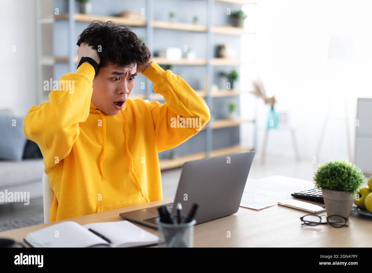 Shocked asian man using laptop hi-res stock photography and images - Alamy