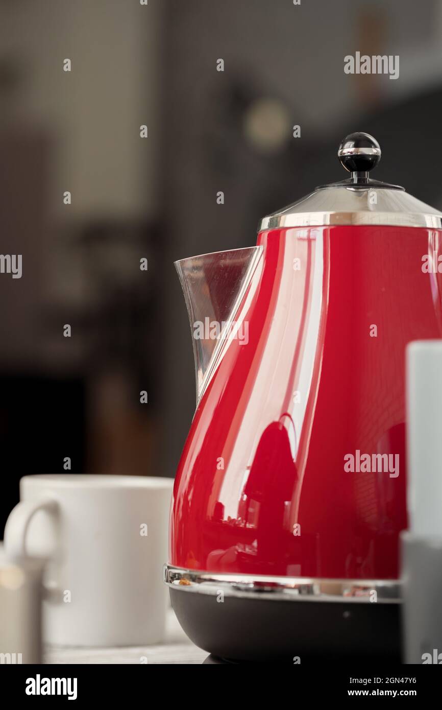Vintage style red electrical teapot in kitchen interior Stock Photo - Alamy