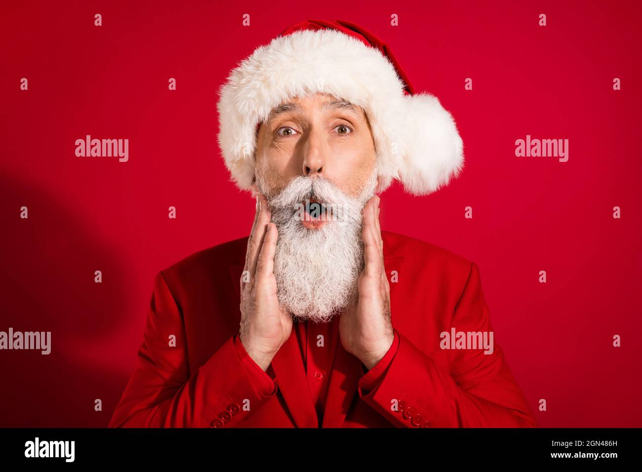 Photo of crazy funky impressed santa claus open mouth hands cheeks wear ...