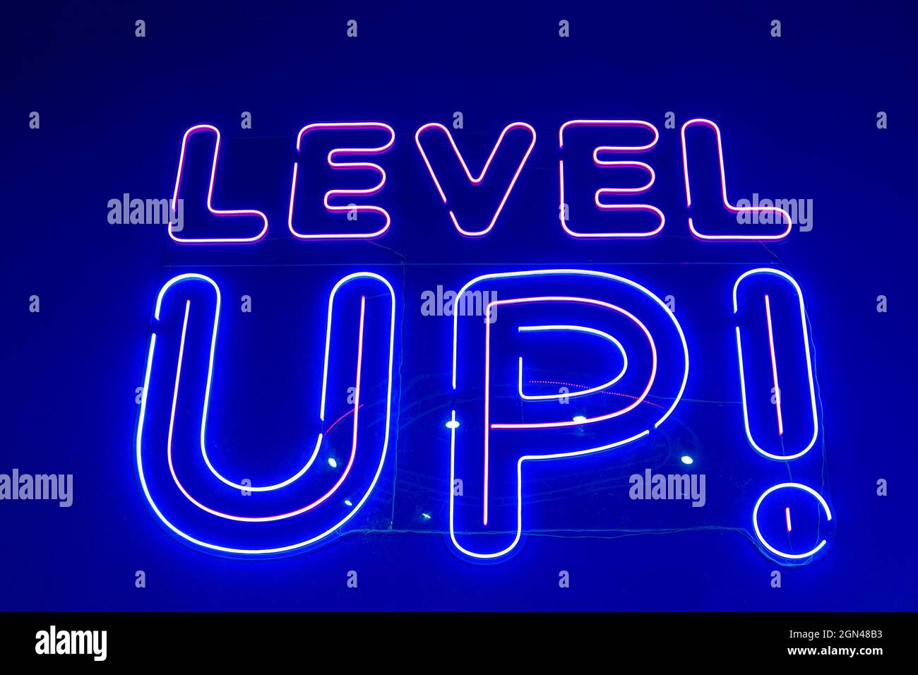 Retro video games zone. Neon sign: Level Up! Stock Photo - Alamy
