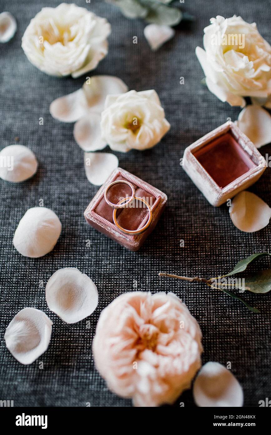 wedding rings in a box on a background of flowers. layout. top view ...