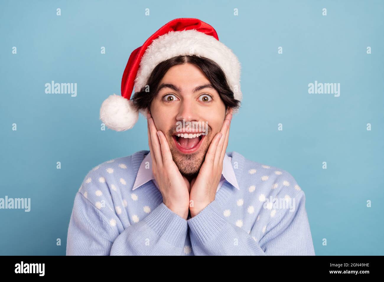 Photo of amazed positive shocked young man hold hands face cheeks ...
