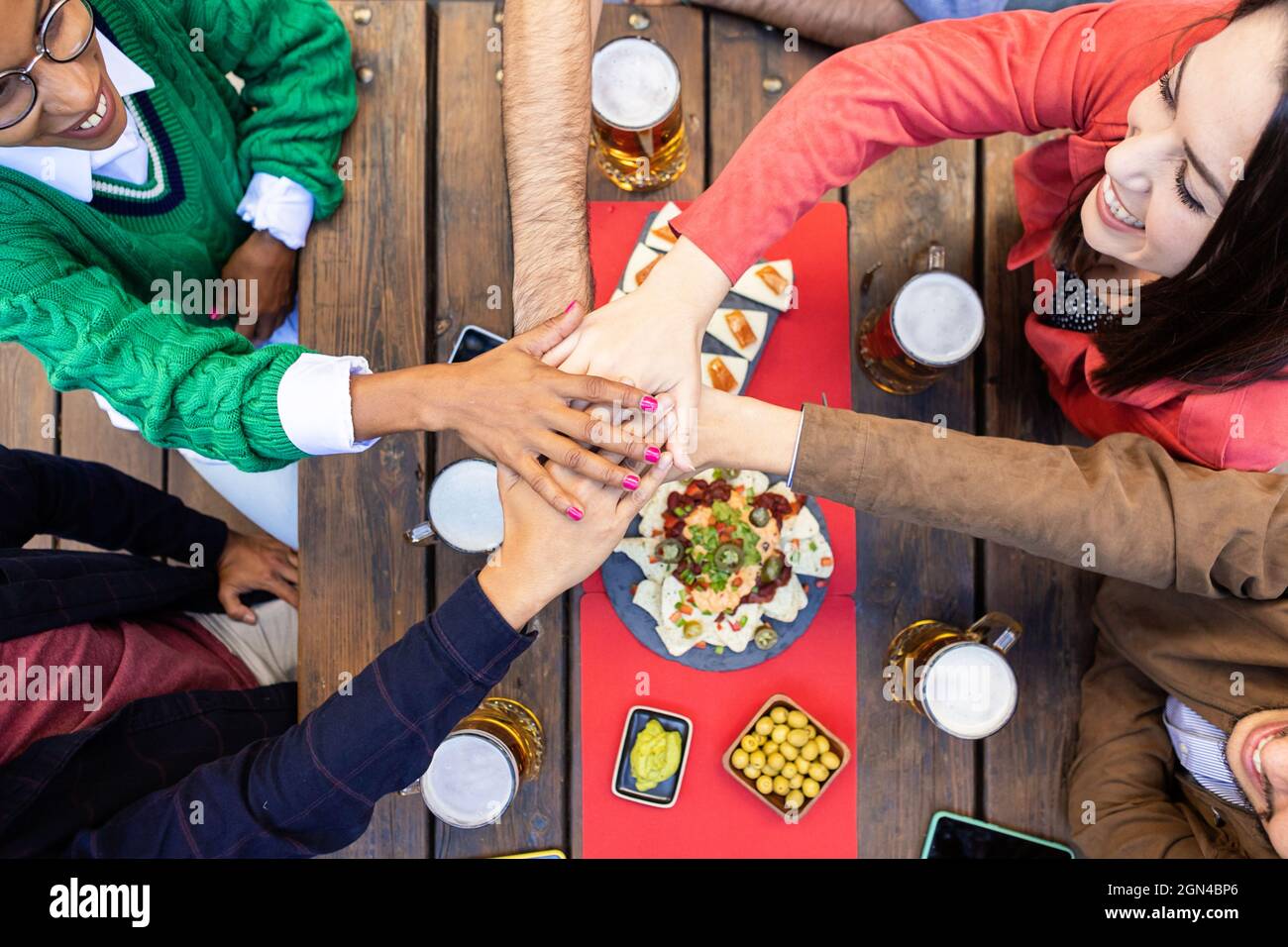 Millennial group of united friends stacking hands Stock Photo - Alamy
