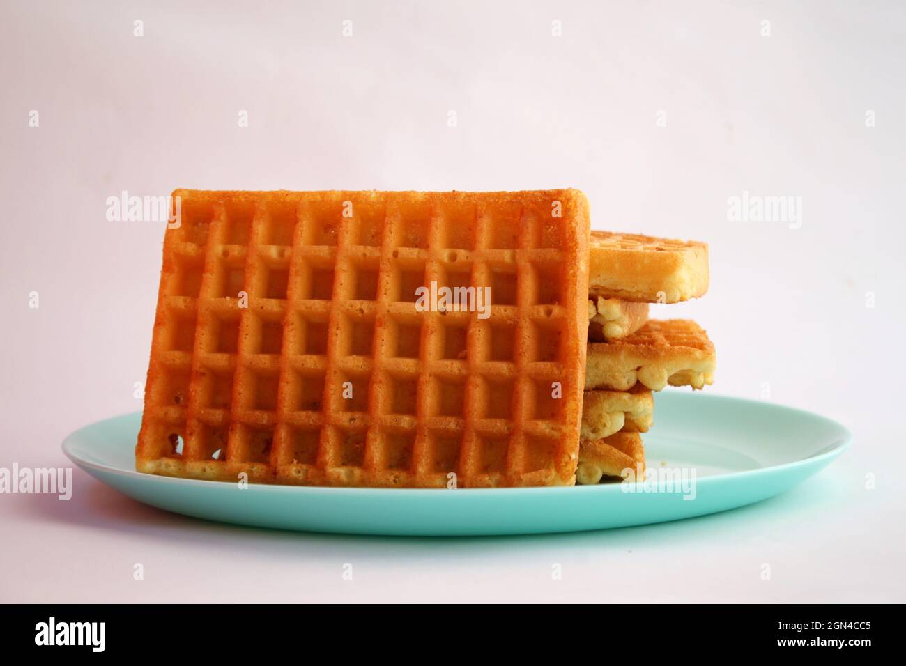 Belgian waffles with apricot jam on turquoise plate Stock Photo - Alamy