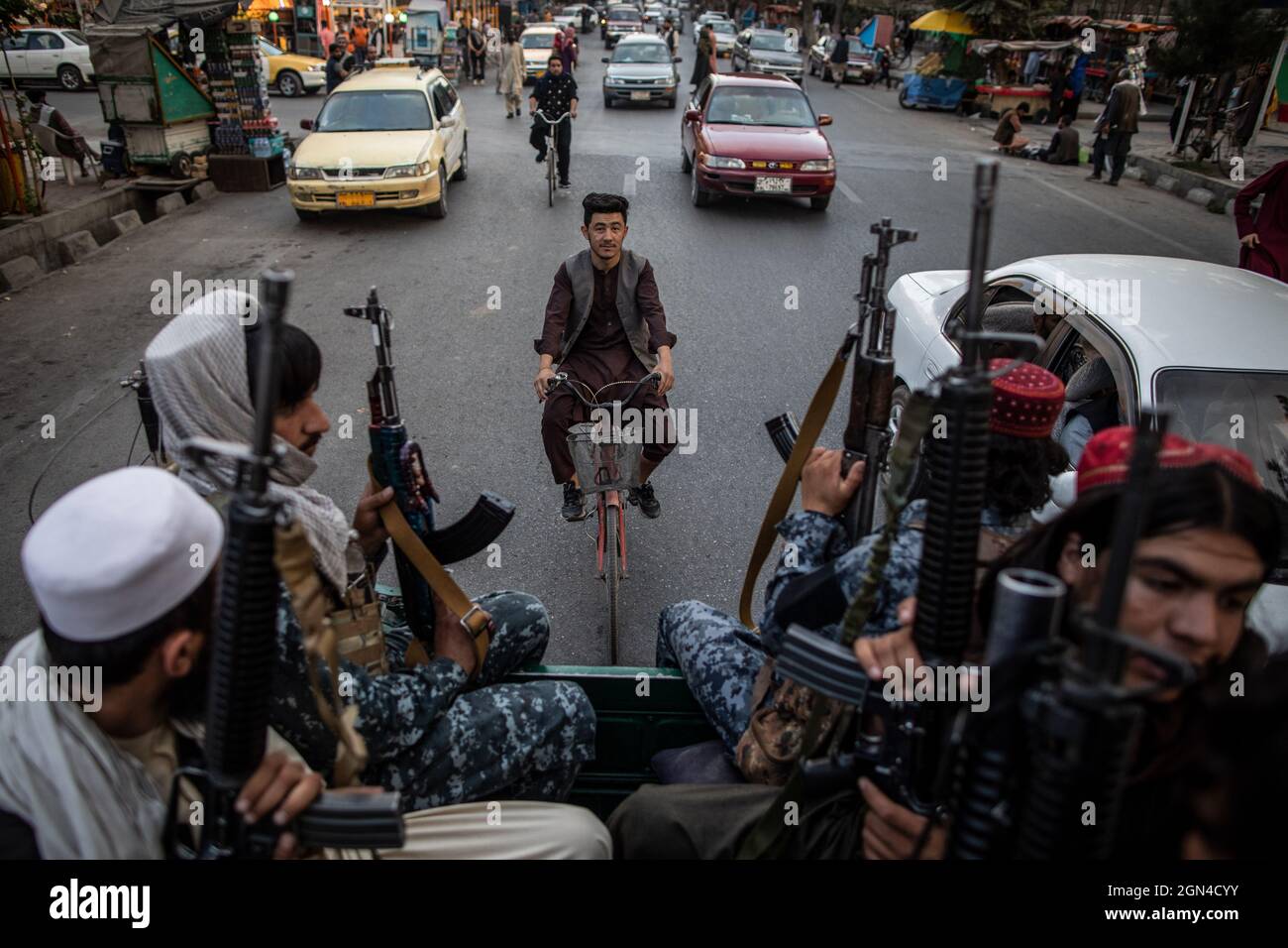 22 September 2021, Afghanistan, Kabul: An Afghan man rides a bicycle as ...