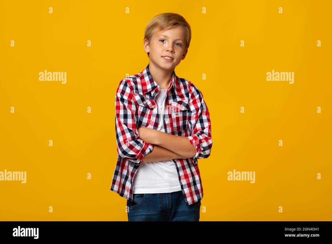 Confident calm european teenage boy in casual with crossed arms looking ...