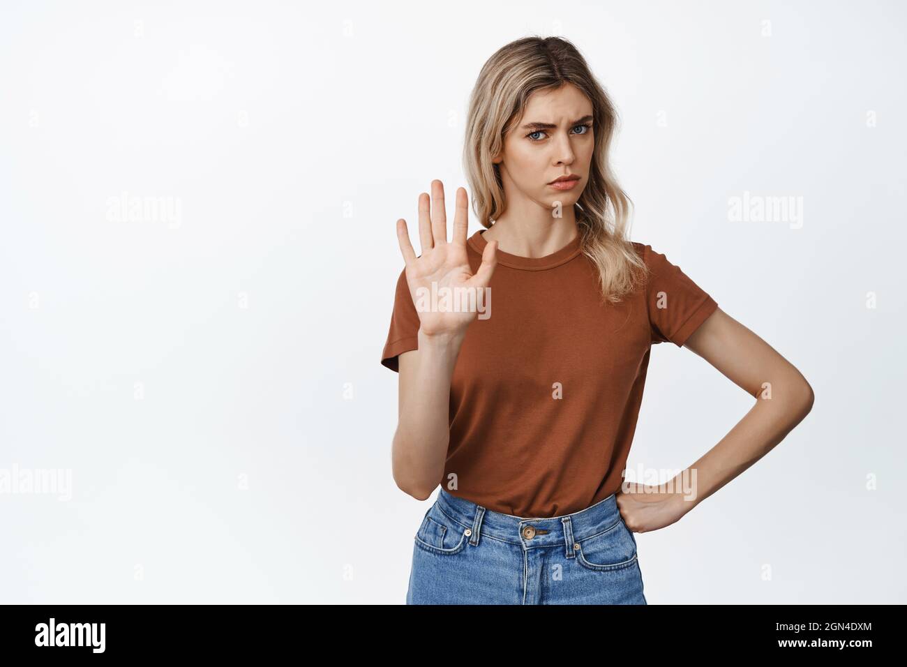 Young serious woman say no, showing stop hand sign, raising arm to ...