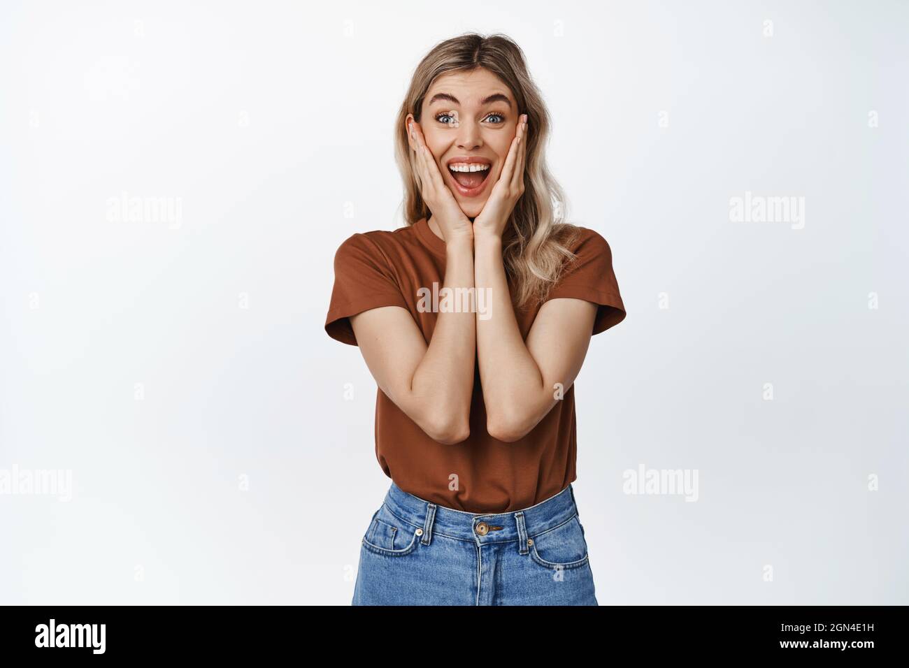 People emotions. Happy young woman laughing and smiling amazed, holding ...