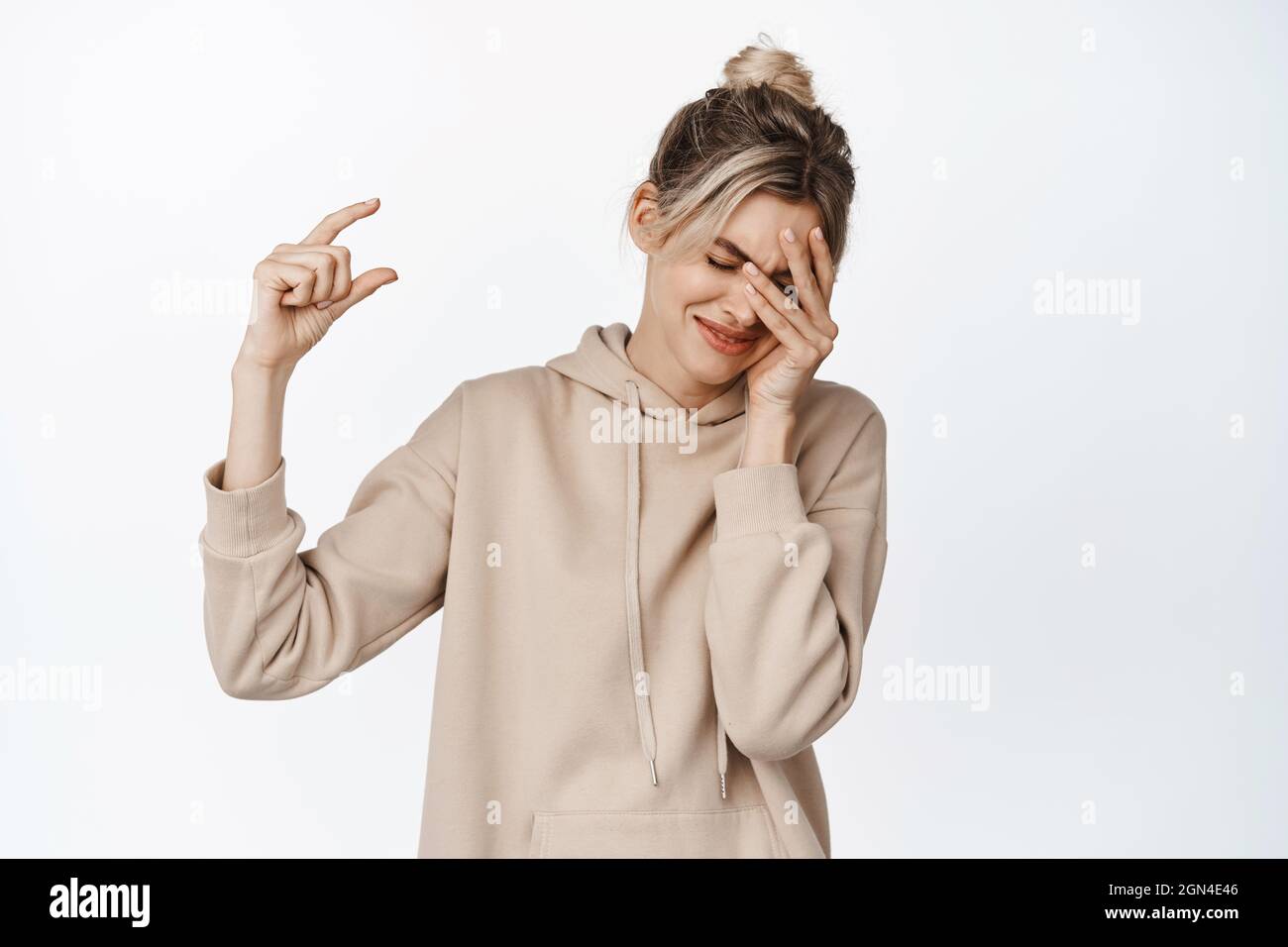 Girl laughs of something tiny, pinching fingers small thing, showing ...