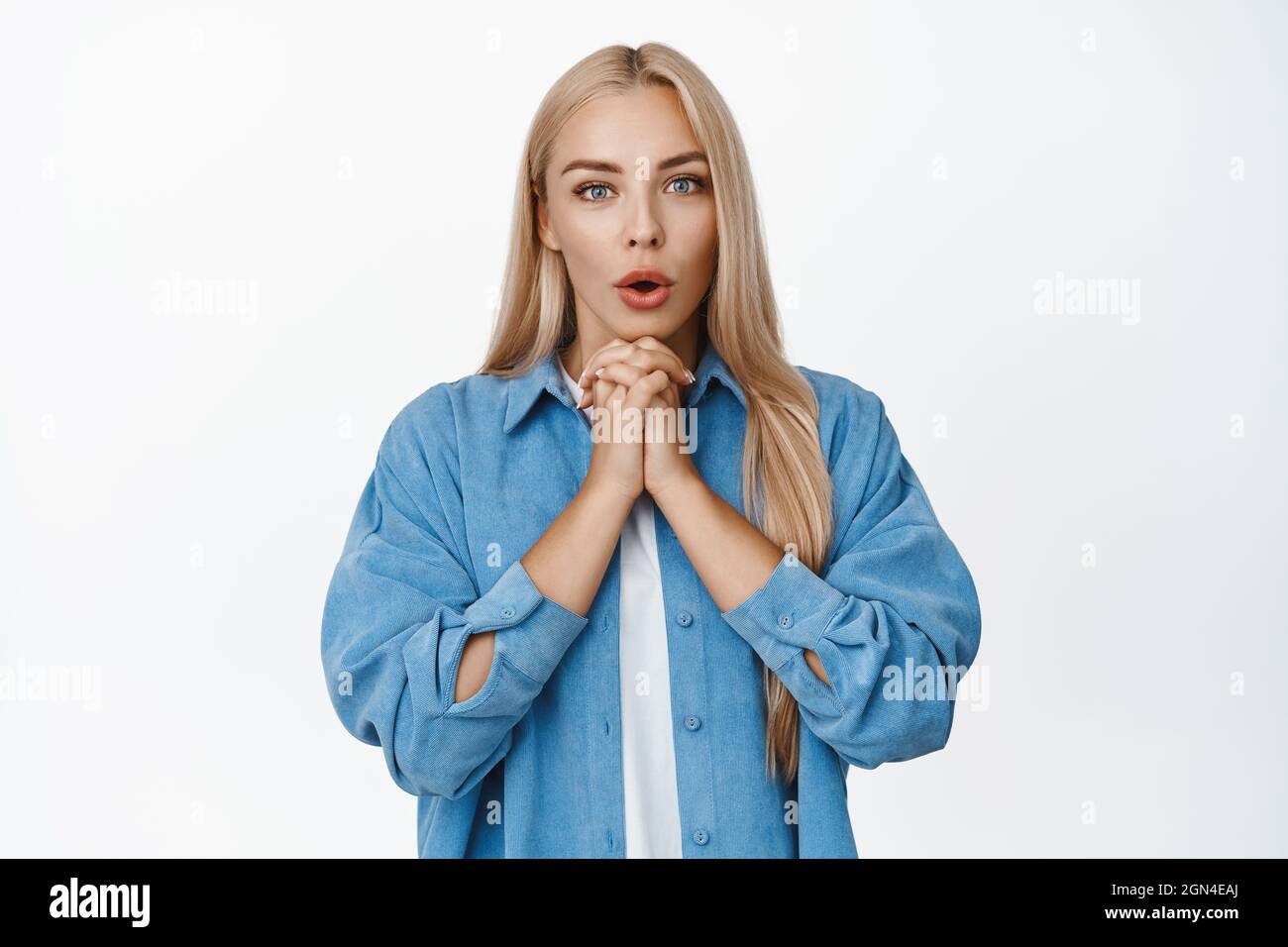 Excited blond woman gasping from anticipation, being on edge with story ...
