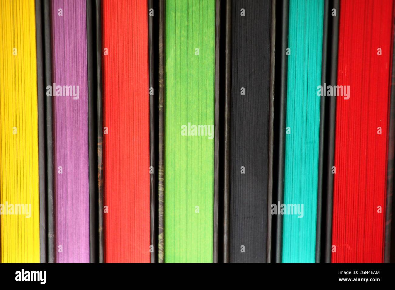 Pile of books with colored pages Stock Photo - Alamy