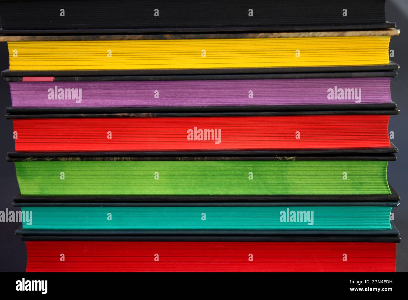 Pile of books with colored pages Stock Photo - Alamy