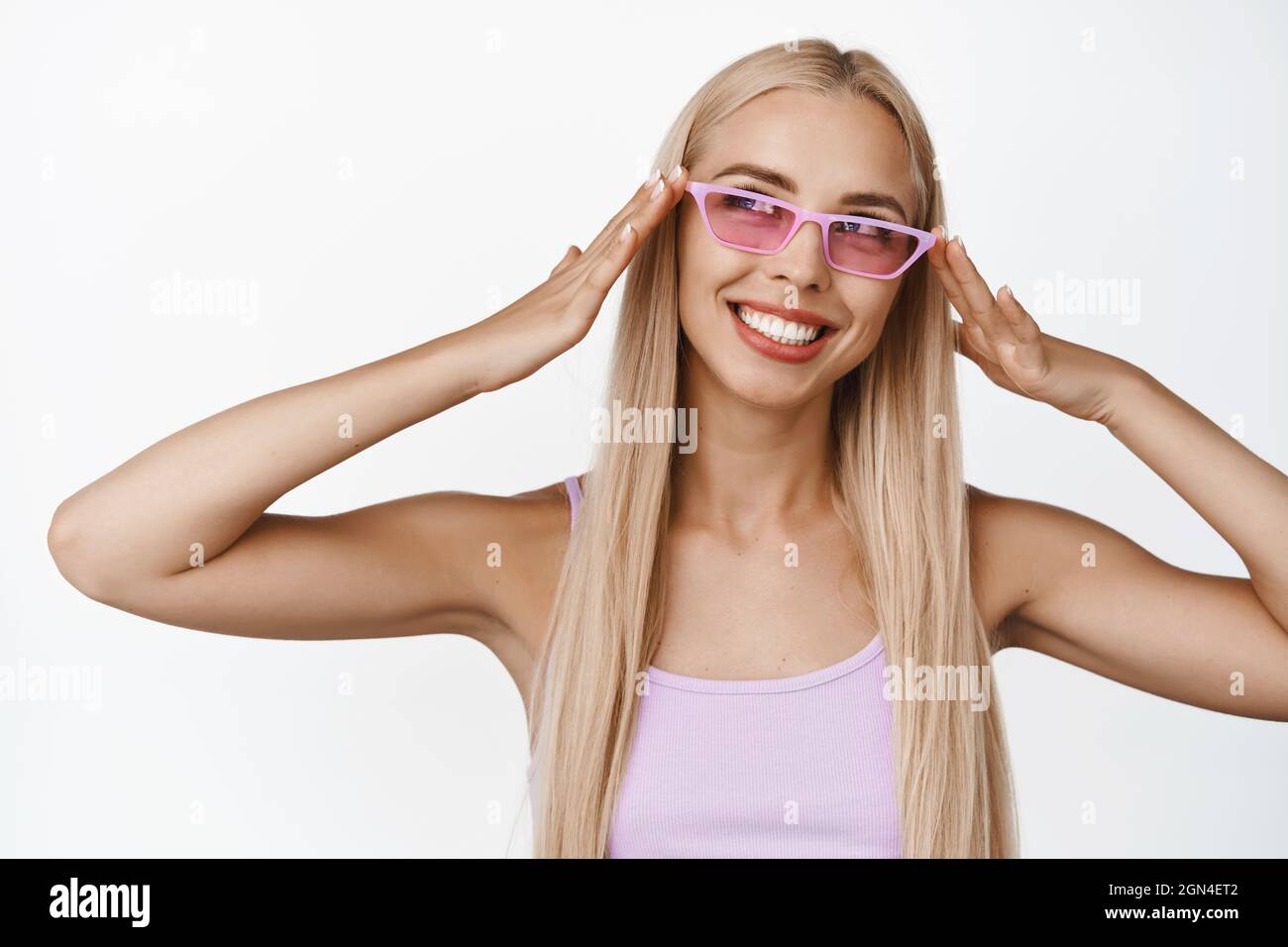 Portrait of stylish blond girl in pink sunglasses, smiling happy and ...