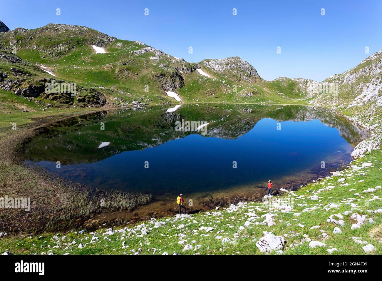 Mother and son walking around beautiful alpine lake manito in the in ...