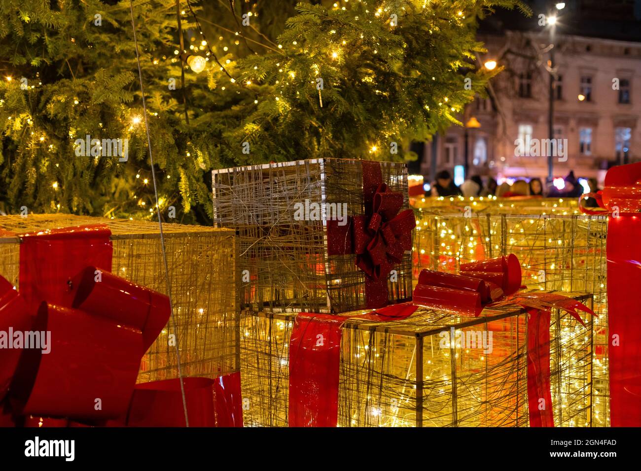 Outdoor Christmas holiday presents decorations gift boxes tied to tree ...