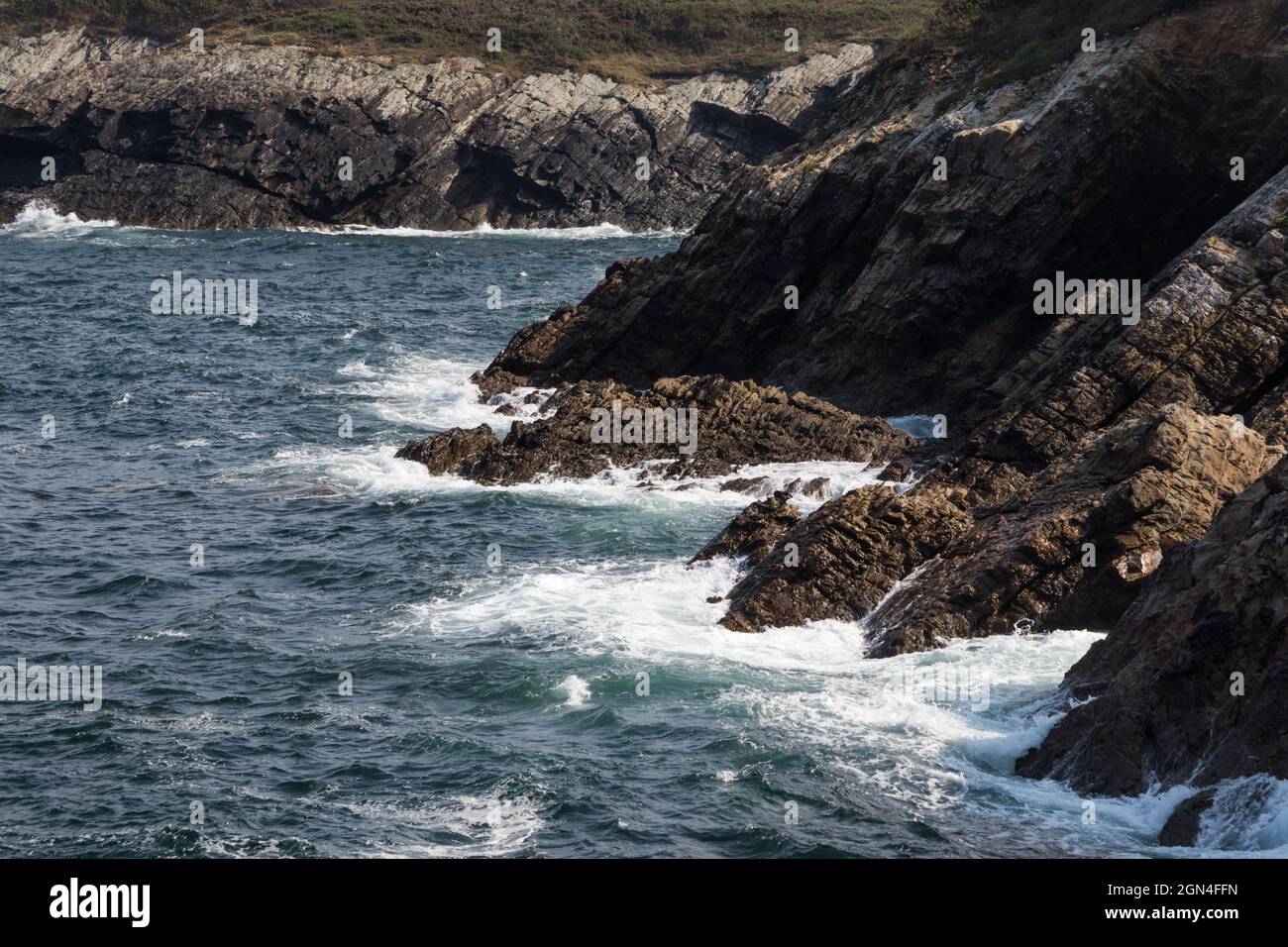 Aerial view of sea waves washing up to rocky cliffs in Isla Pancha ...