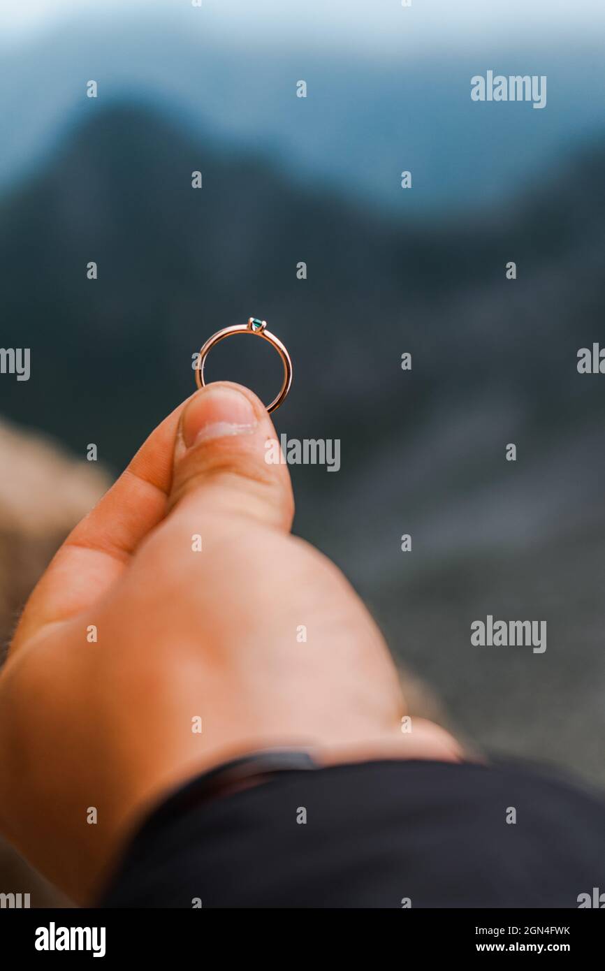 Closeup of a man's hand holding an engagement ring for proposal Stock ...