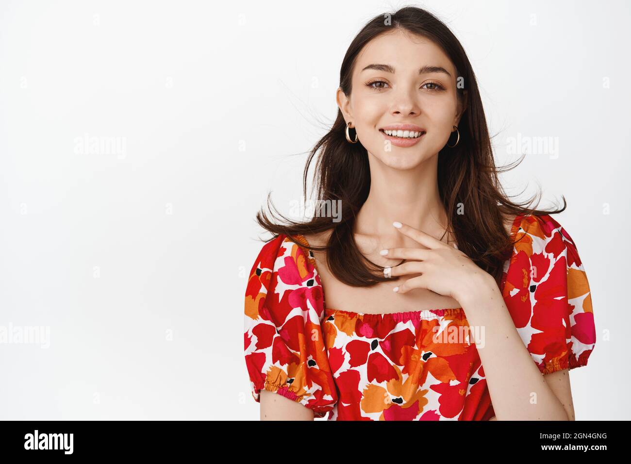 Women beauty. Tender smiling girl touching her skin, wearing floral ...