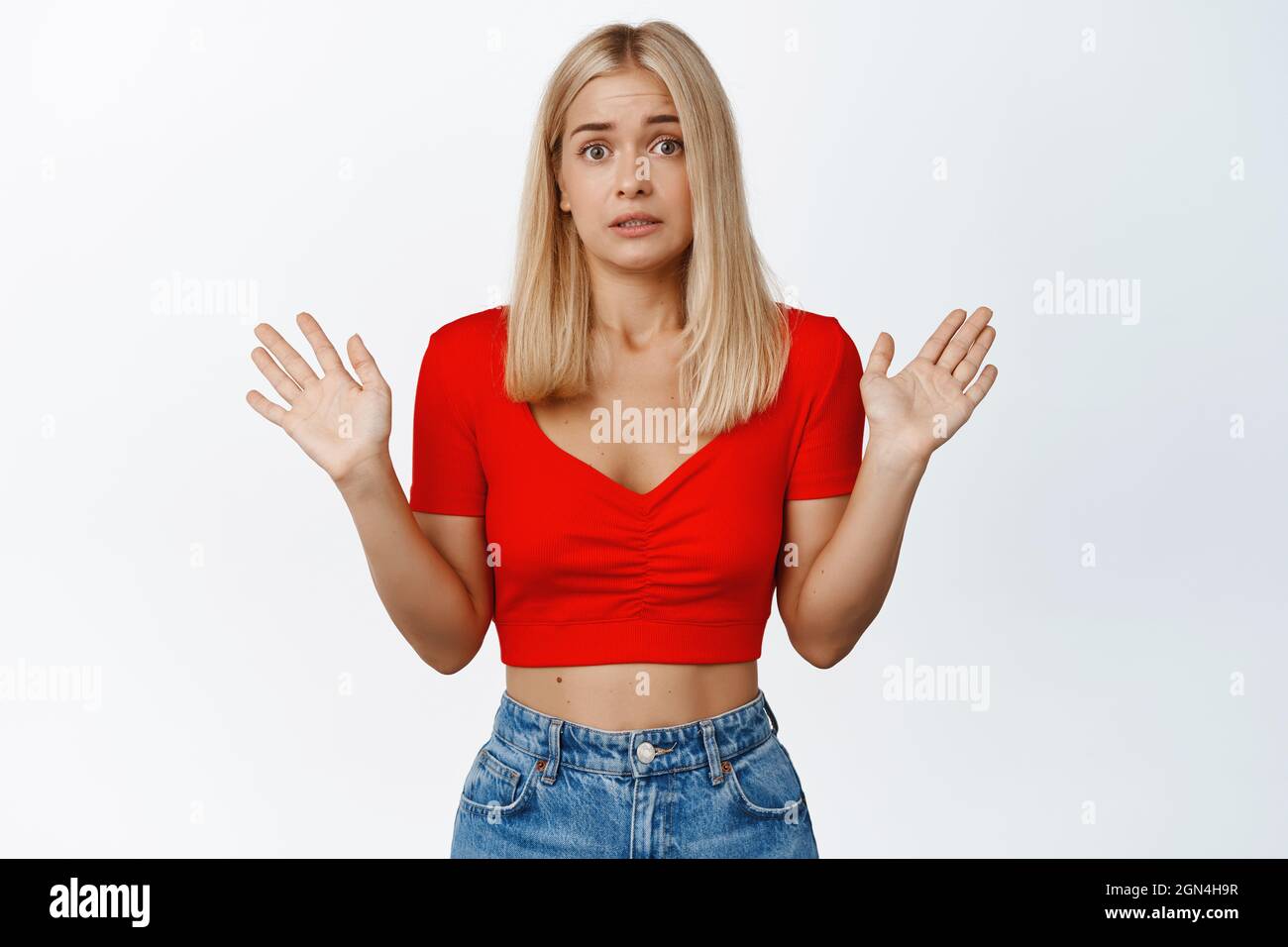 Young woman raising hands up saying sorry, has nothing to do with ...