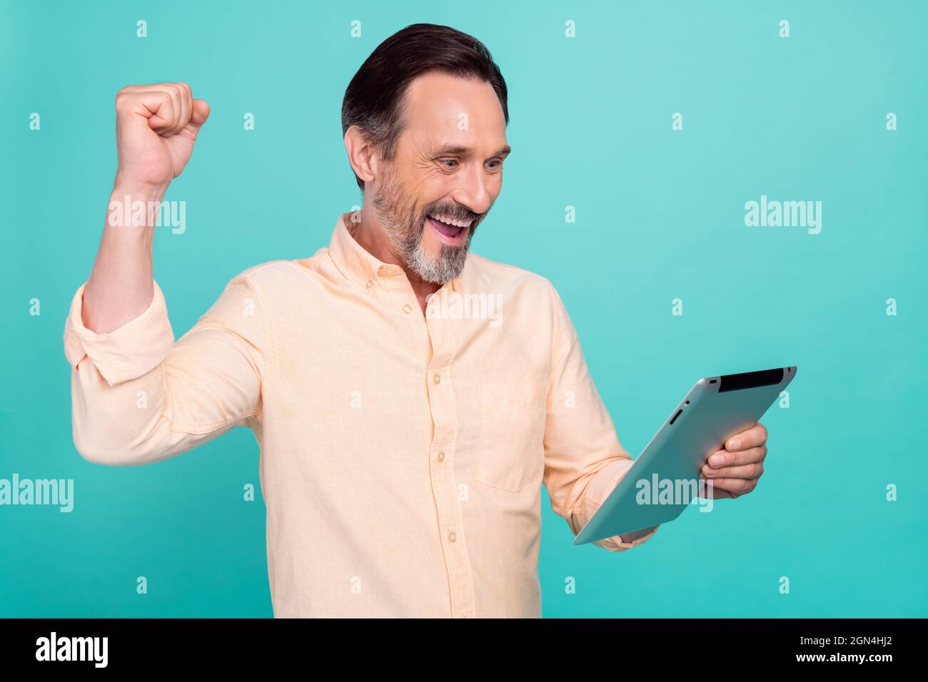 Photo of cheerful smiling handsome mature businessman raise fist in ...