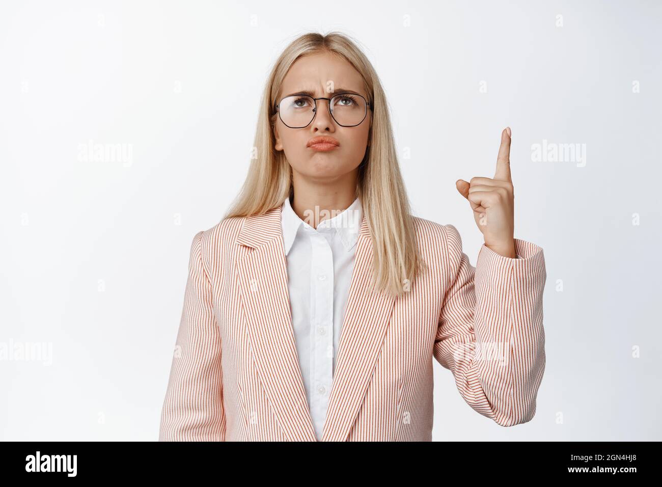 Grumpy employee in suit and glasses, pointing finger up and looking ...
