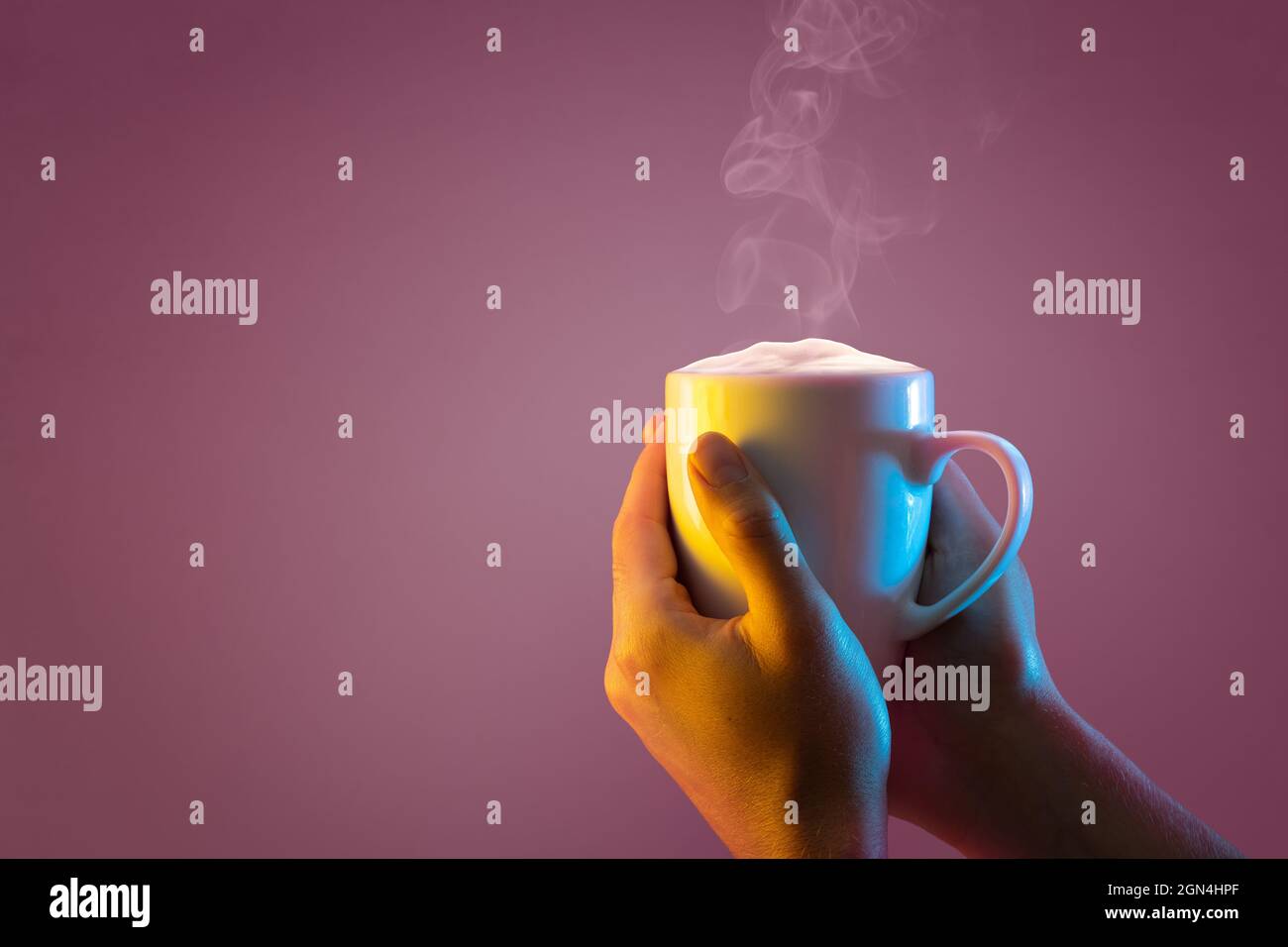 Hands holding a mug with a hot beverage Stock Photo - Alamy