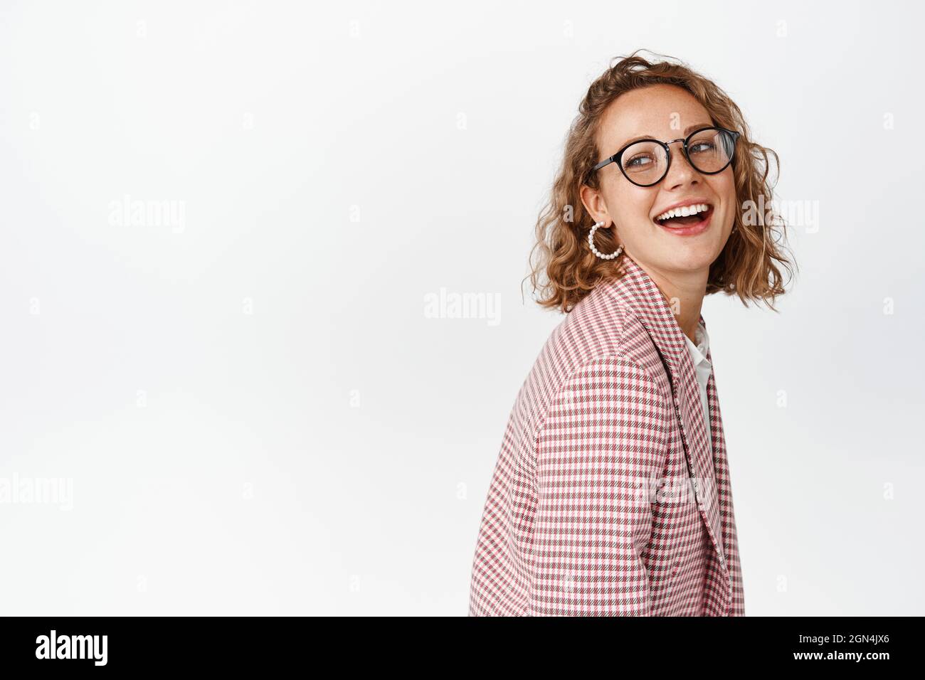 Portrait of beautiful young businesswoman in glasses and stylish suit ...