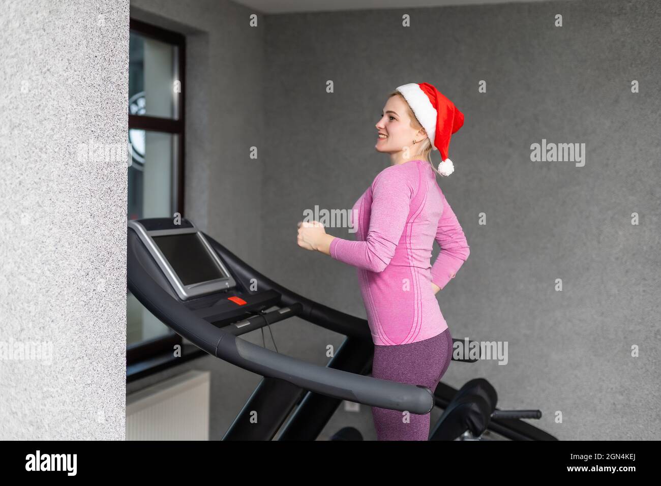 Girl trainer in Santa Claus. New year's eve workout concept Stock Photo ...