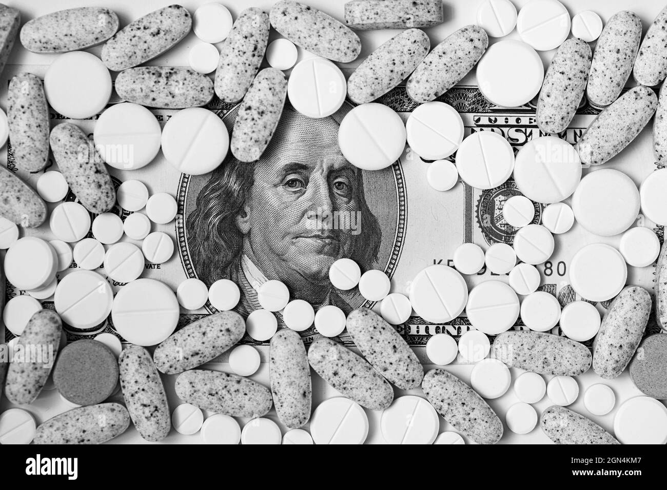 100 Dollar Bancknote In Pile Of Assorted Pilss Background Stock Photo 100-dollar-bancknote-in-pile-of-assorted-pilss-background-stock-photo