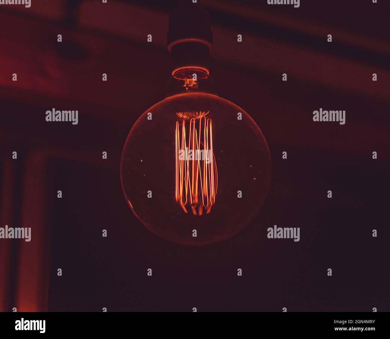 Closeup of the light bulb filament glowing in the darkness Stock Photo ...
