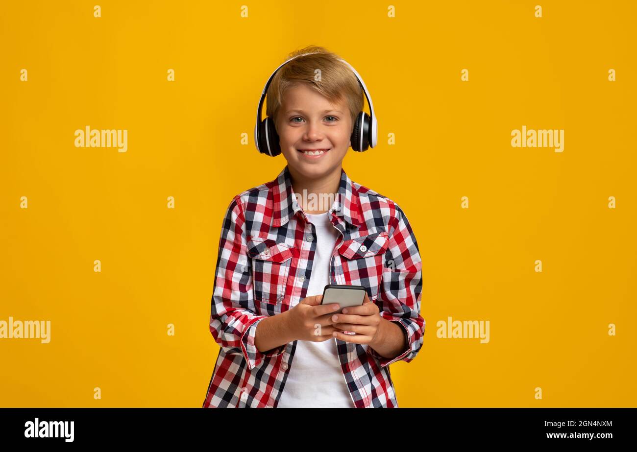 Happy boy child smartphone earphones hi-res stock photography and ...