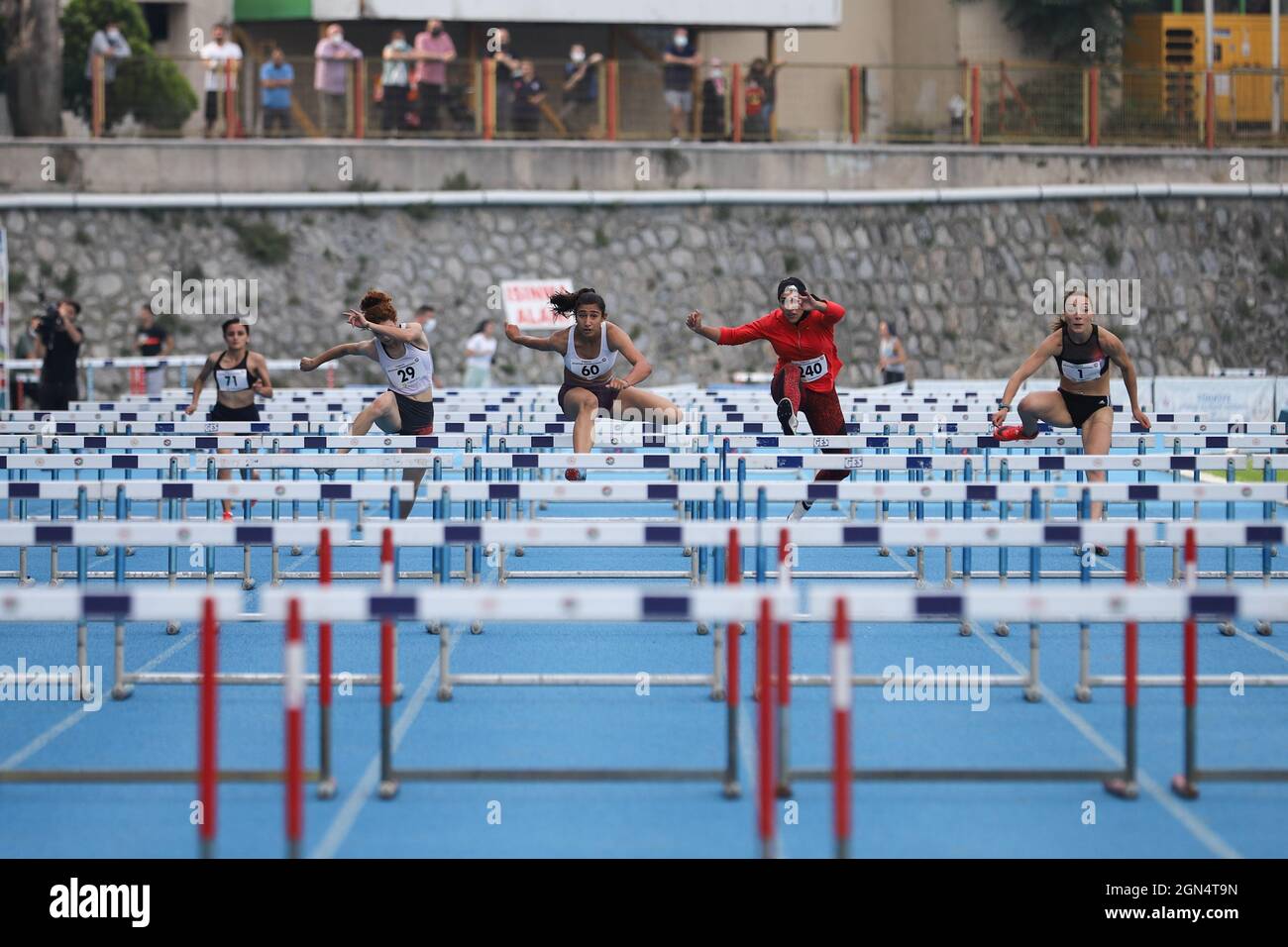 ISTANBUL, TURKEY - JUNE 23, 2021: Athletes running 100 metres hurdles ...