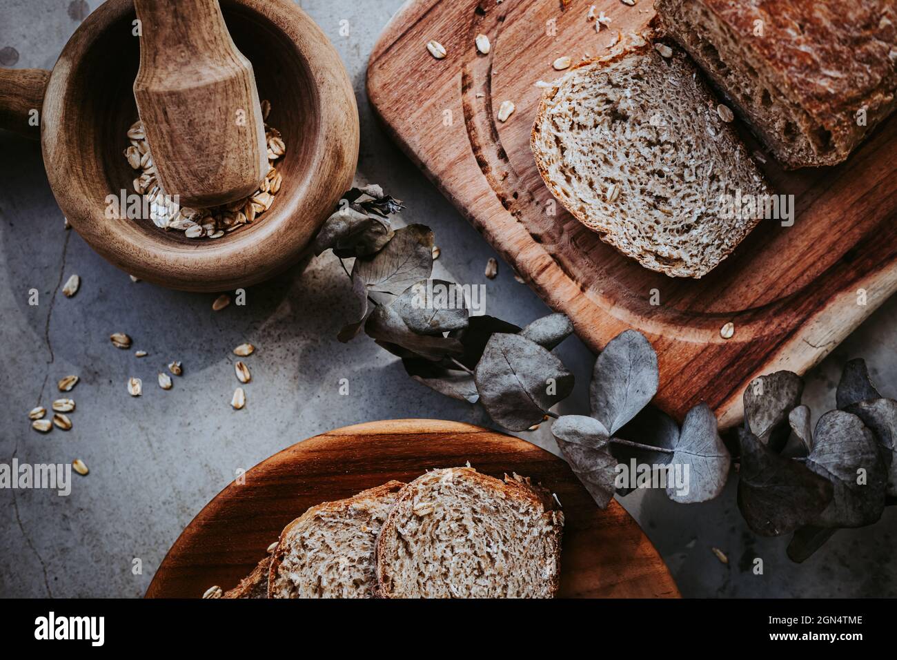 Loaf and slices of oat wheat bread and a eucalyptus branch Stock Photo ...